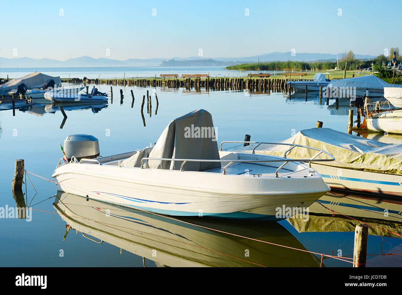 Landscape with the boats on a lake in the sunrise light. Italy Stock ...
