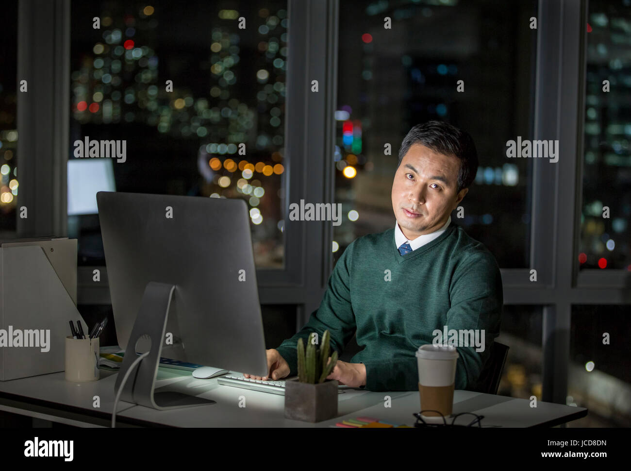 Stressful businessman working night overtime Stock Photo - Alamy