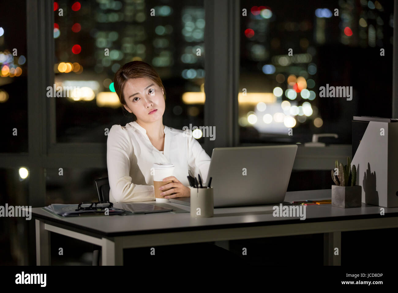 Businesswoman working overtime at night Stock Photo - Alamy