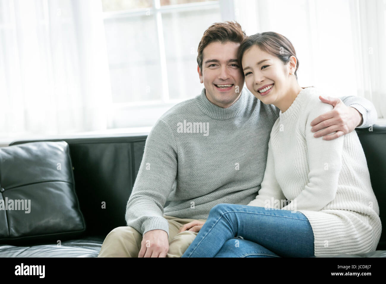 Smiling multicultural family couple Stock Photo - Alamy