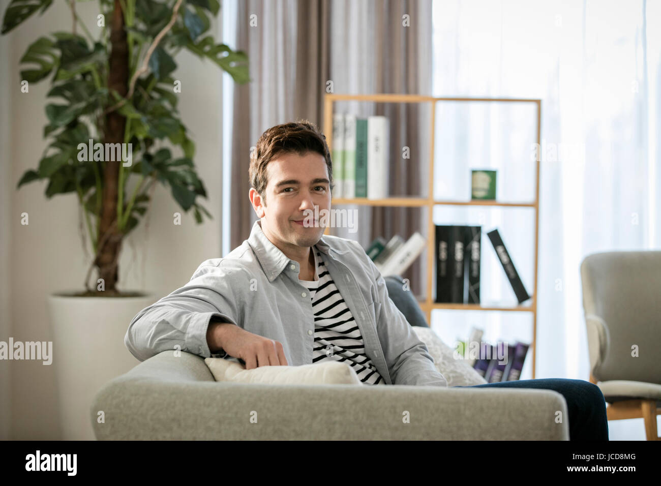 Relaxing man sitting on sofa hi-res stock photography and images - Alamy