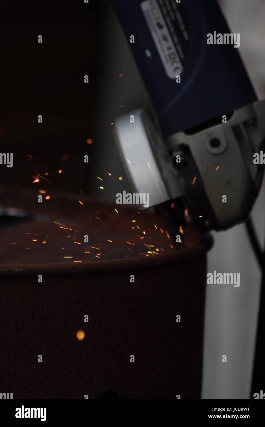 Angle Grinder, Cutting Oil Drum Lid, Orange Sparks. Exeter, Devon. June ...