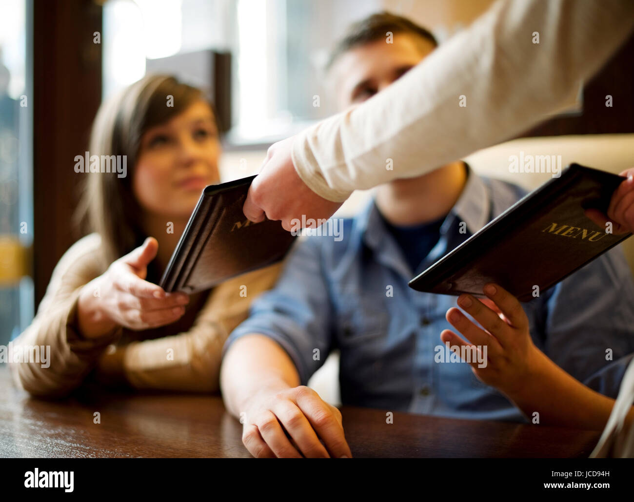 Couple giving order to waiter hi-res stock photography and images - Alamy