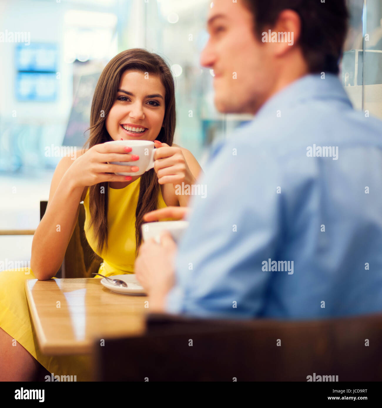 Couple enjoying a coffee Stock Photo - Alamy