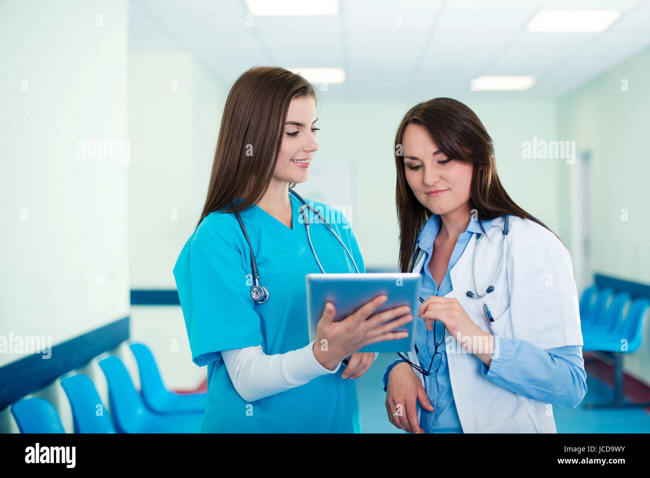 Female doctors checking results on digital tablet Stock Photo - Alamy