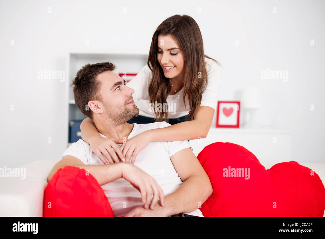 Men being embraced by him girlfriend Stock Photo - Alamy