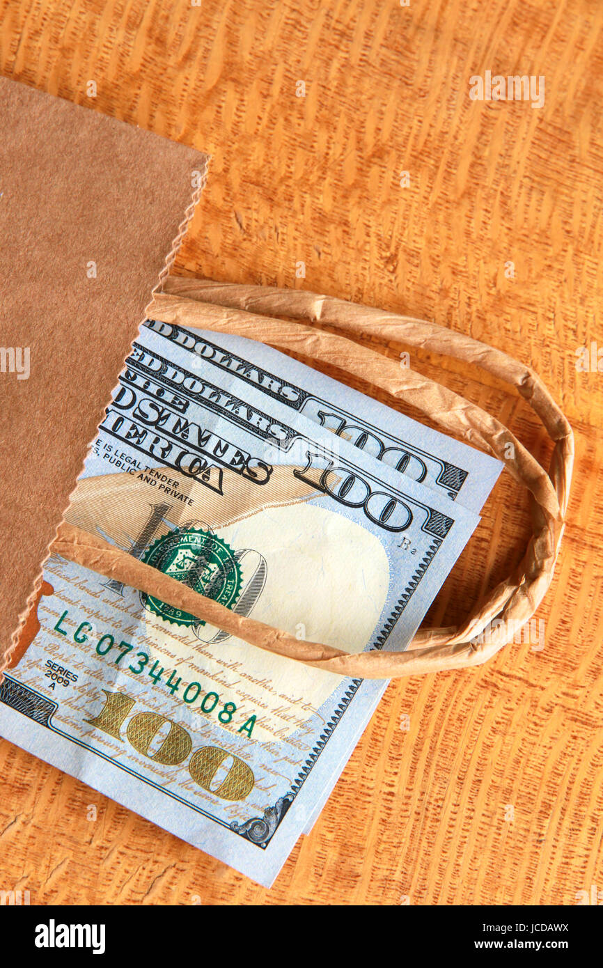 American dollars in a brown paper bag Stock Photo - Alamy
