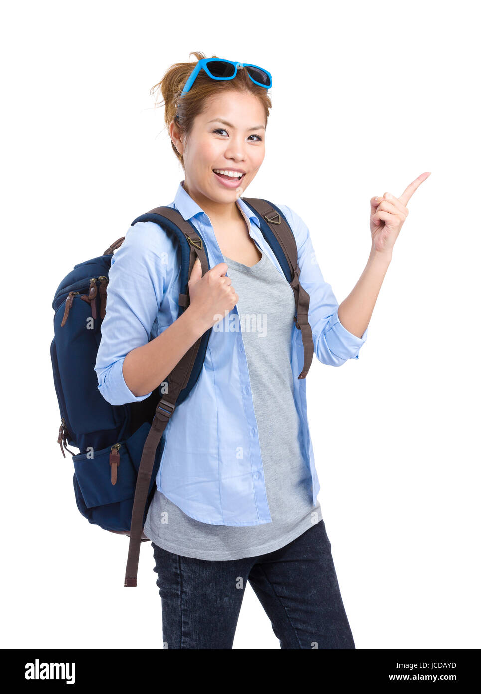 Woman with backpack and finger point up Stock Photo - Alamy