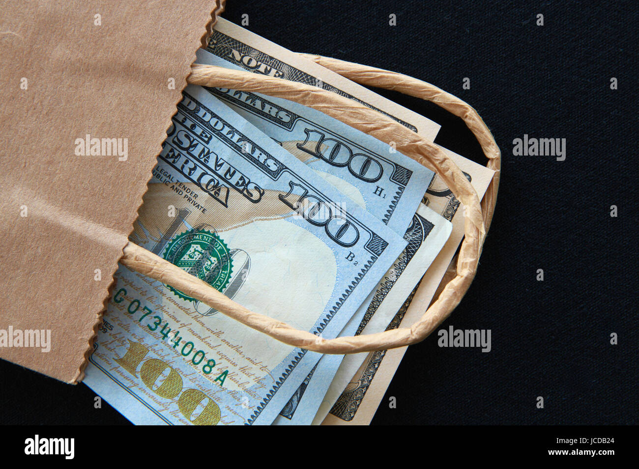 American dollars in a brown paper bag Stock Photo - Alamy