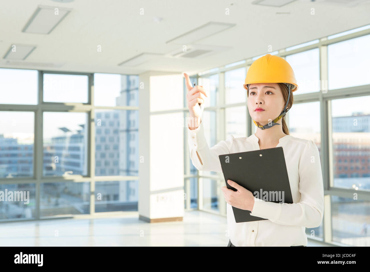 Young female architect pointing hi-res stock photography and images - Alamy