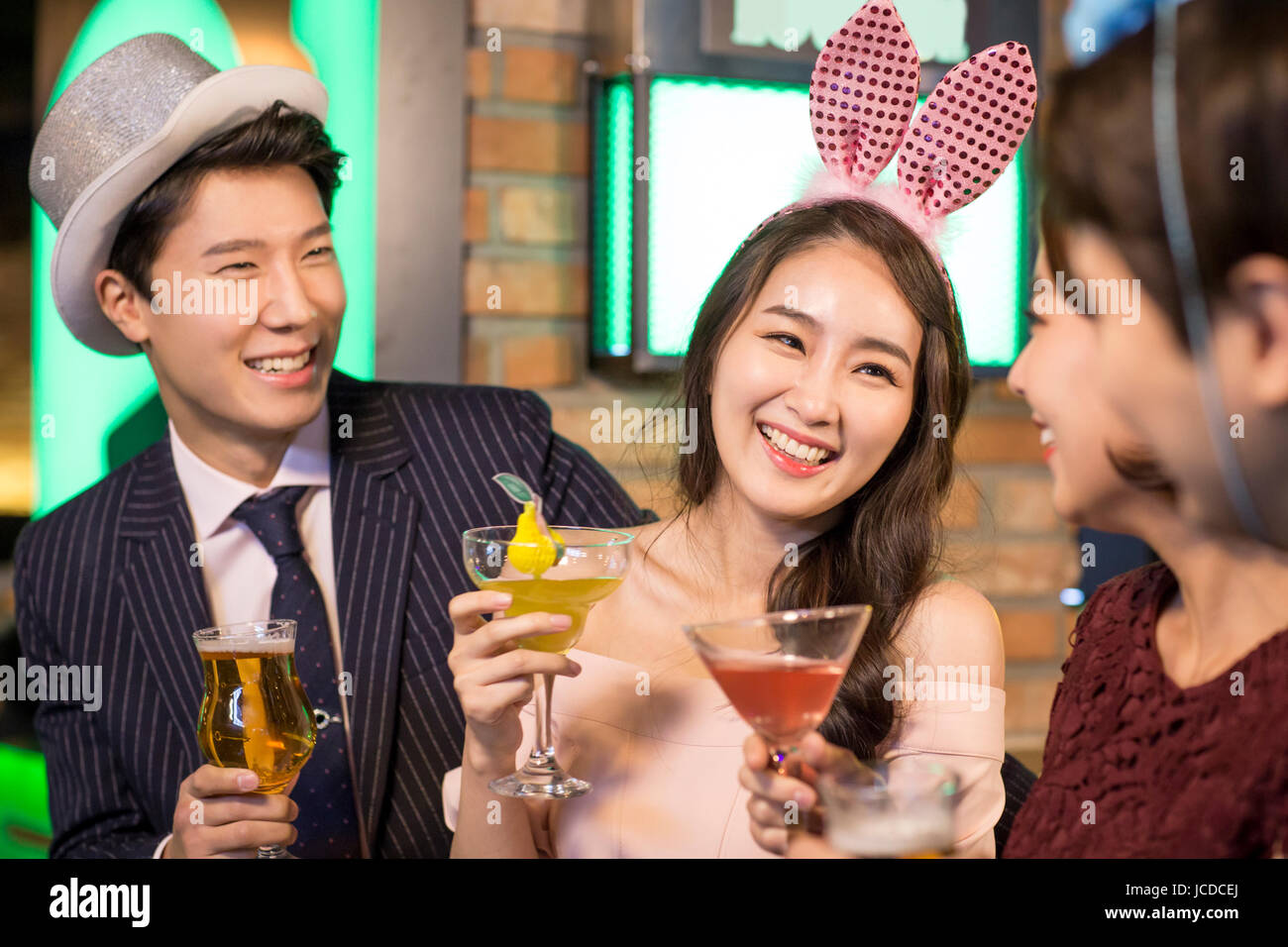 Portrait of young smiling people having a party Stock Photo - Alamy