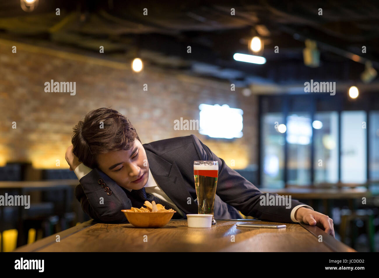 Portrait of single businessman drinking alone Stock Photo - Alamy