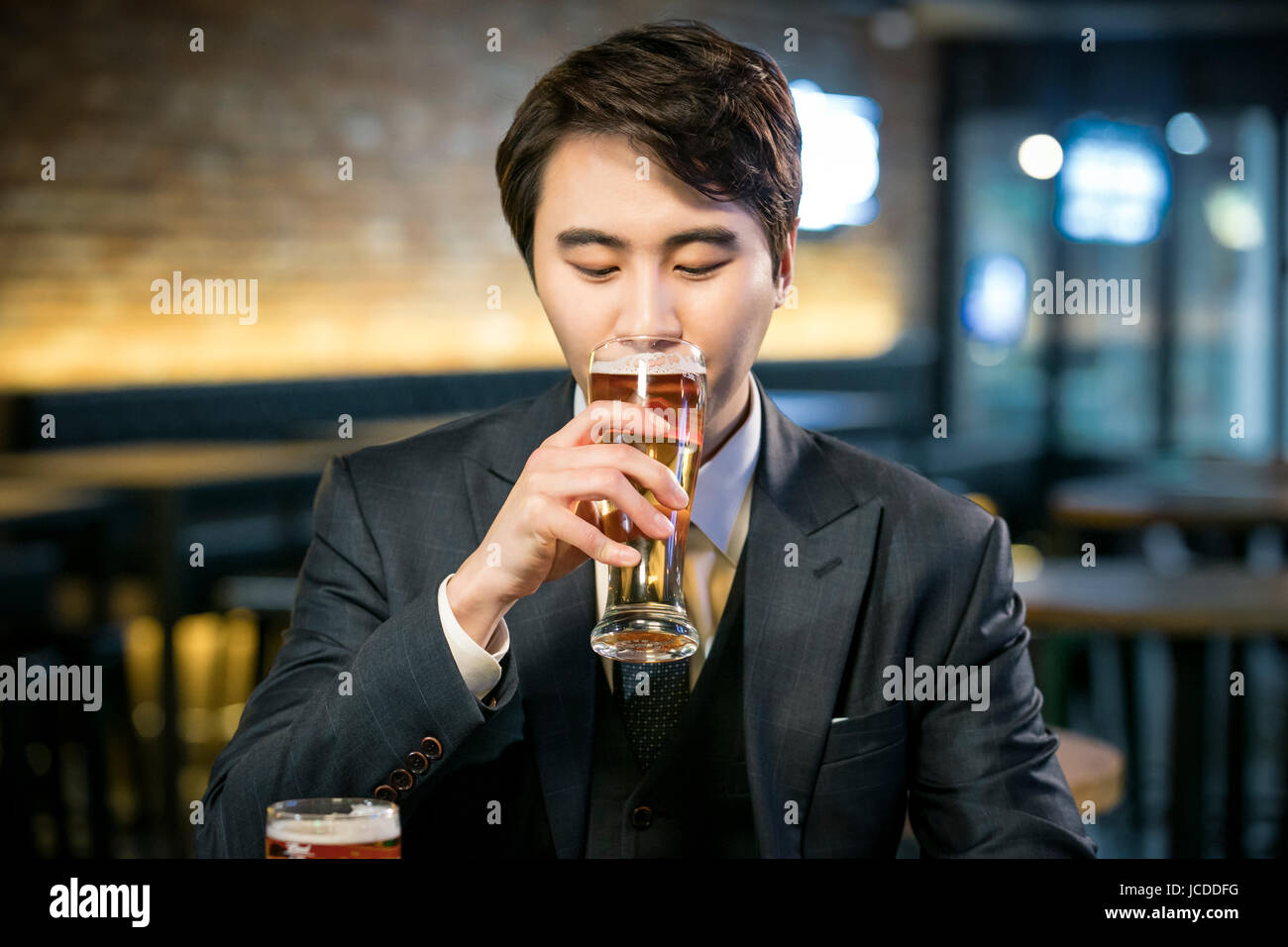 Portrait of single man drinking alone at bar Stock Photo - Alamy