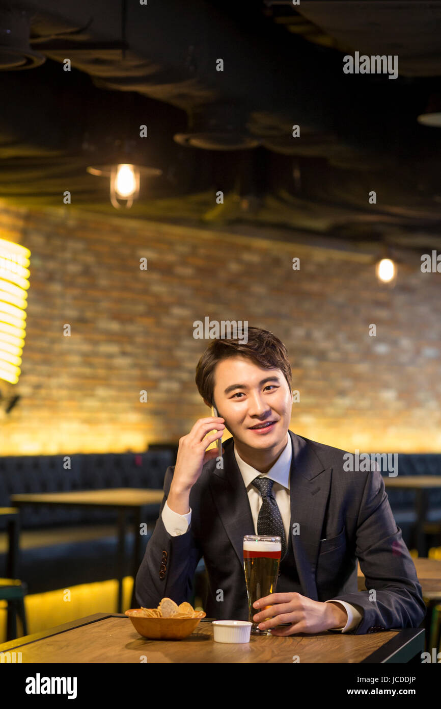 Portrait of smiling single man at bar Stock Photo - Alamy