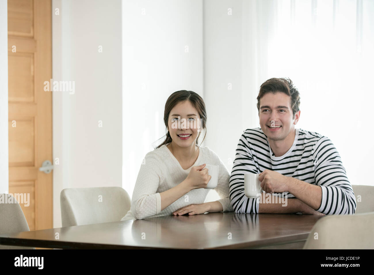 Portrait of smiling multicultural family couple Stock Photo - Alamy
