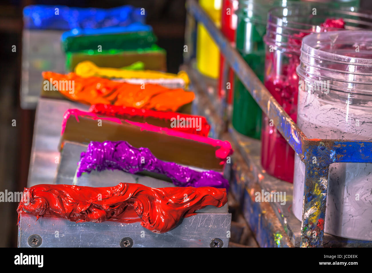 ink on rubber handle hang on place above plastisol ink in cans ready ...