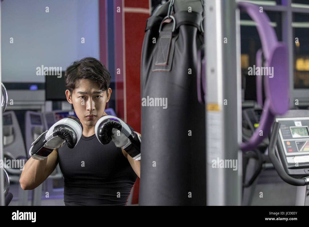 Portrait of young man boxing at health club Stock Photo - Alamy
