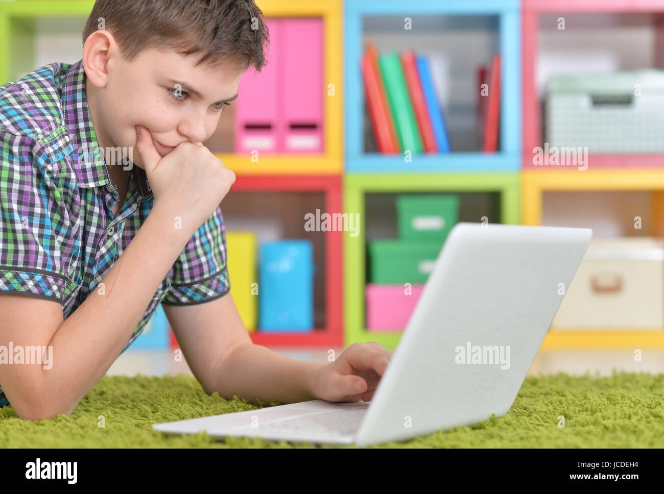 Portrait of a teenage boy with a laptop Stock Photo - Alamy