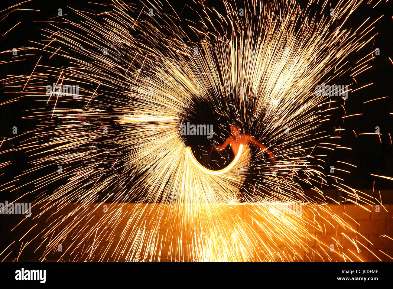 Beautiful fire show with a lot of sparks in the night Stock Photo - Alamy