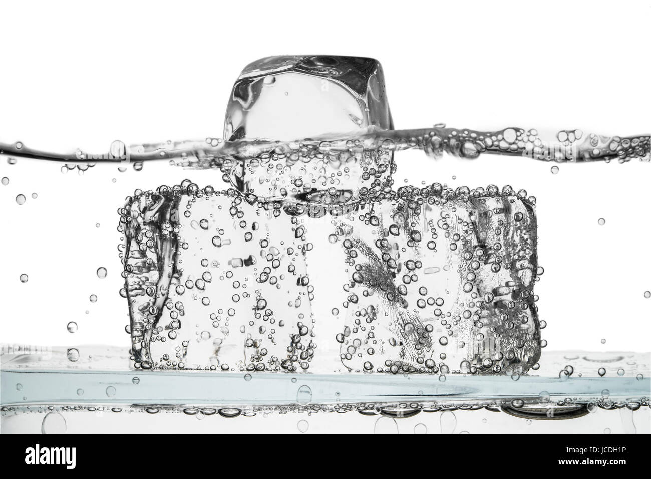 Ice cubes falling into the water surface Stock Photo - Alamy