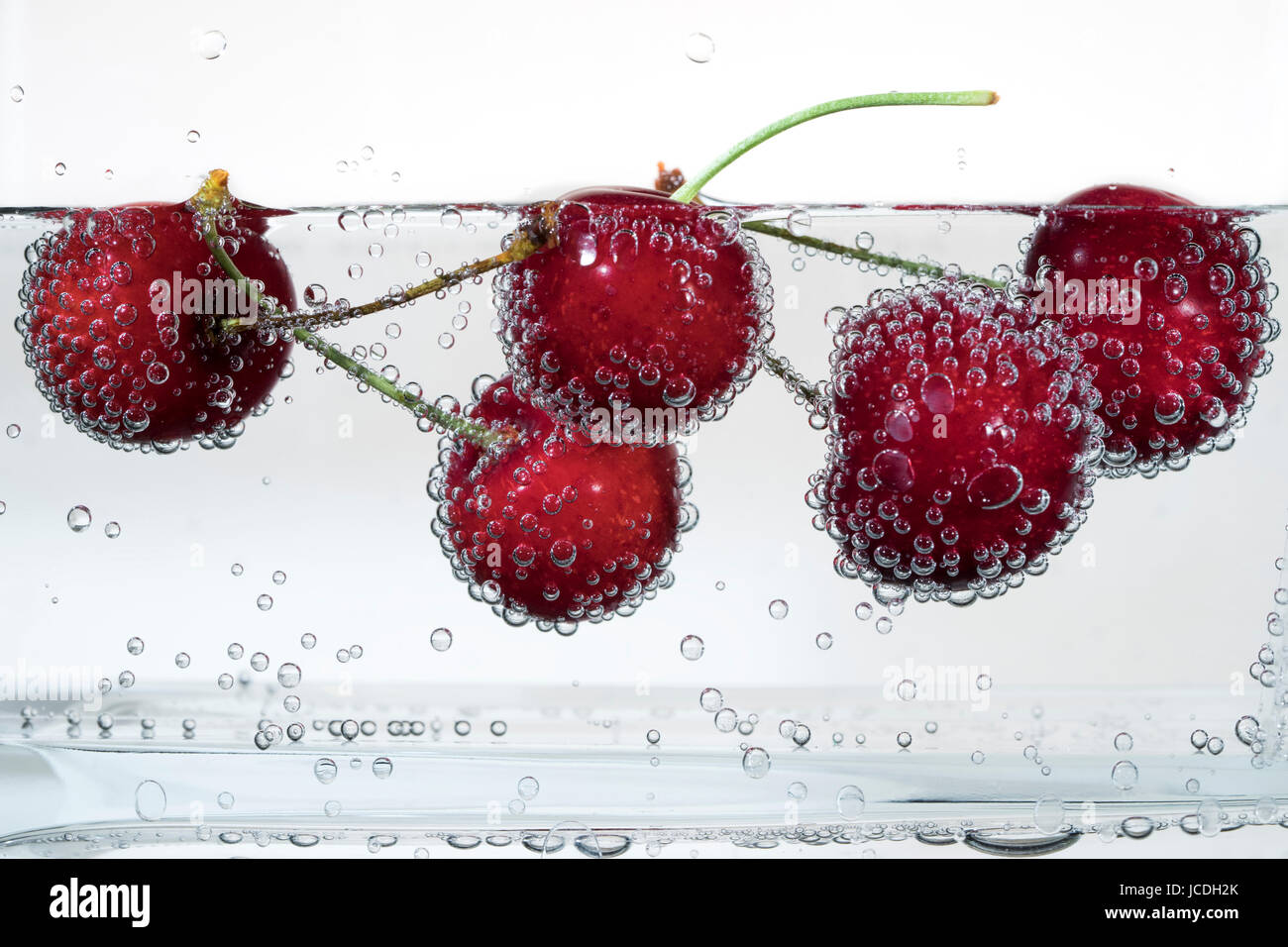 Floating in bubble water ripe cherries Stock Photo - Alamy