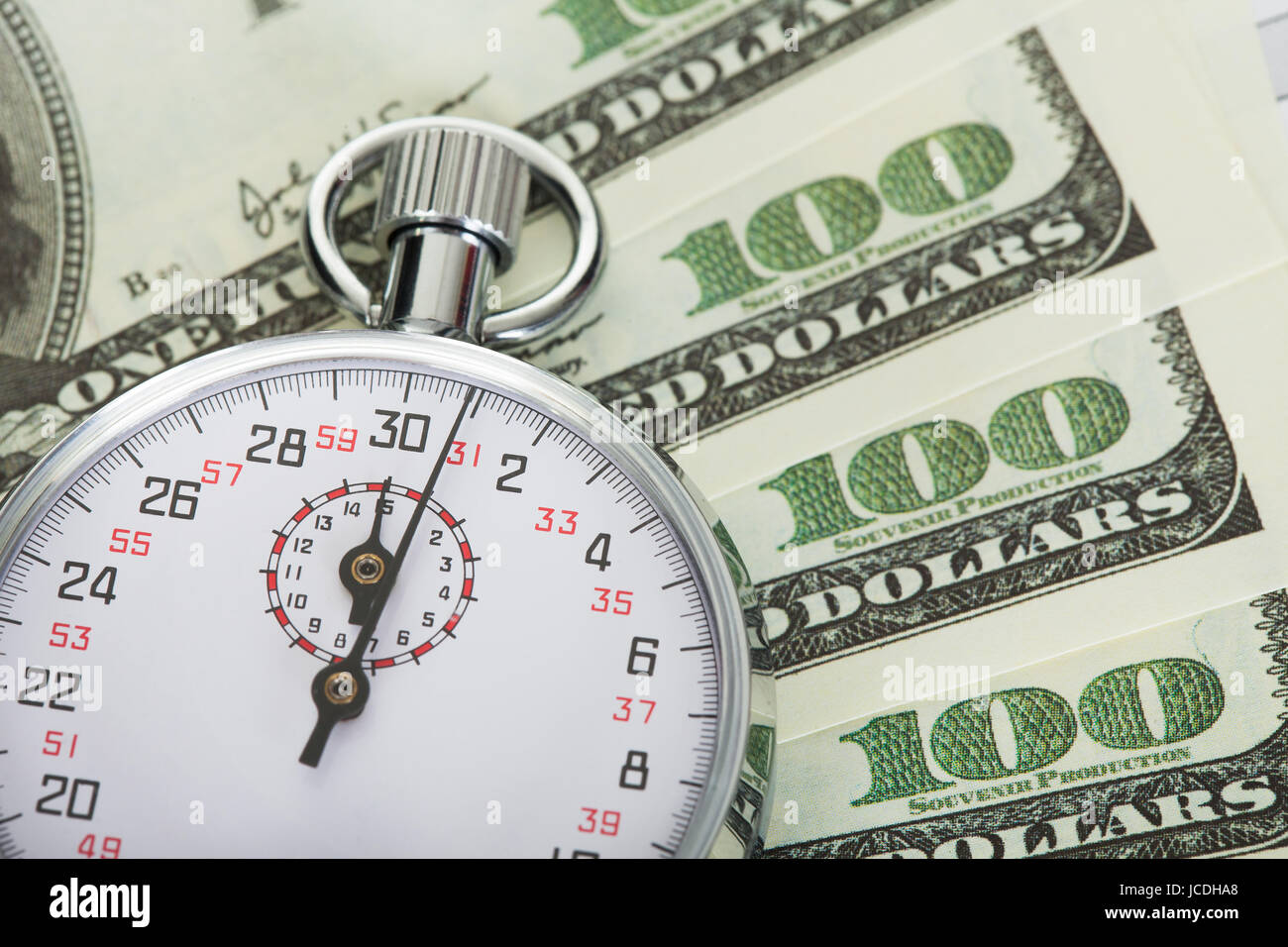 Stopwatch and dollars. Time is money concept Stock Photo - Alamy
