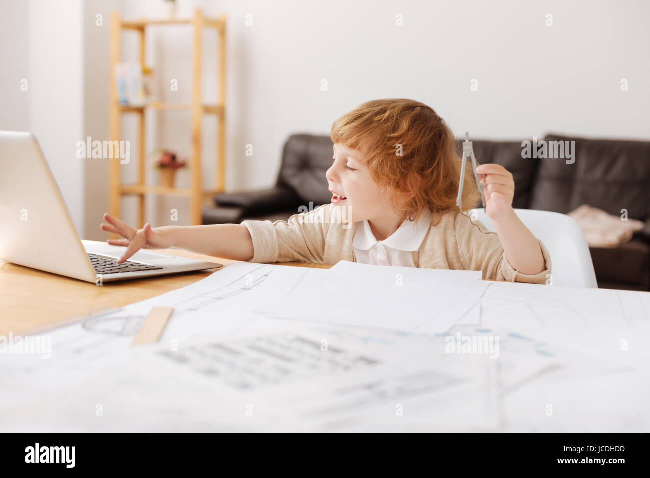 Enigmatical kid pressing the button on laptop Stock Photo - Alamy