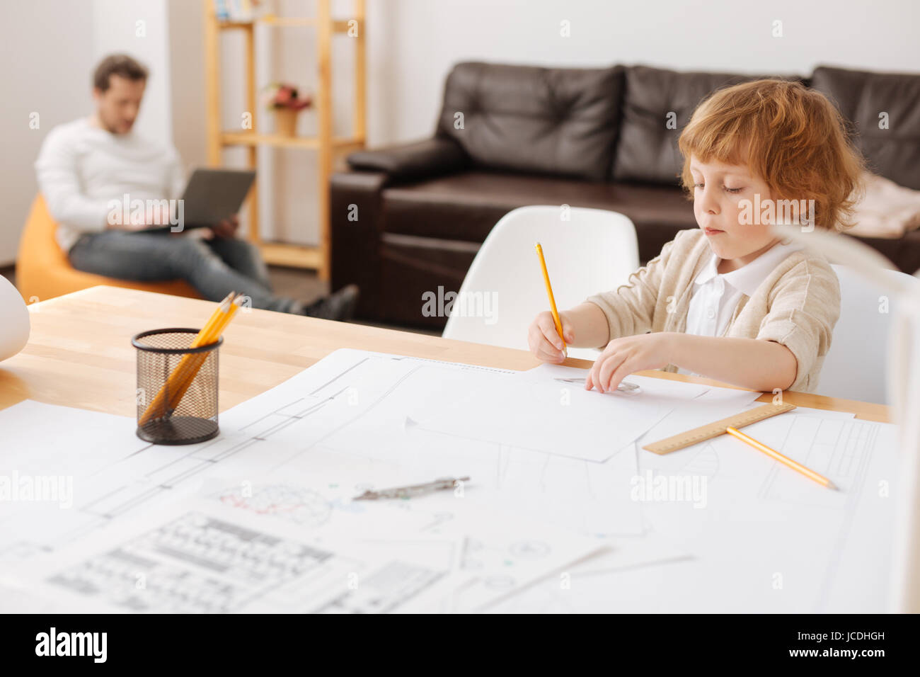 Concentrated kid being busy while working in office of his father Stock ...