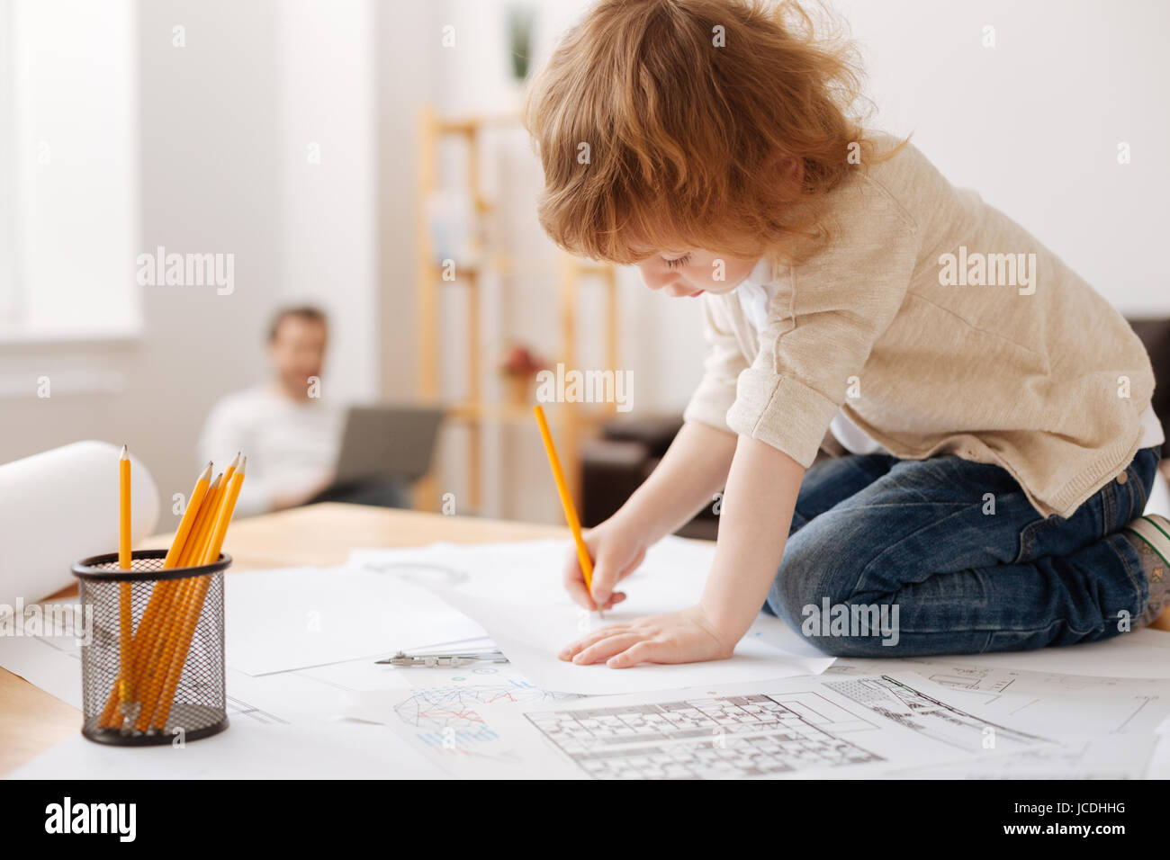 Serious boy drawing picture on the paper Stock Photo - Alamy