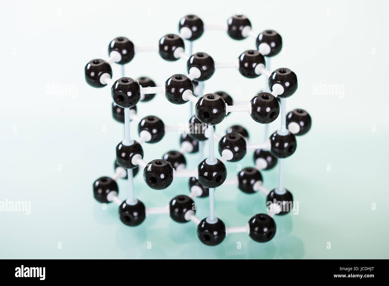 Model of graphite molecular structure on green reflective background ...