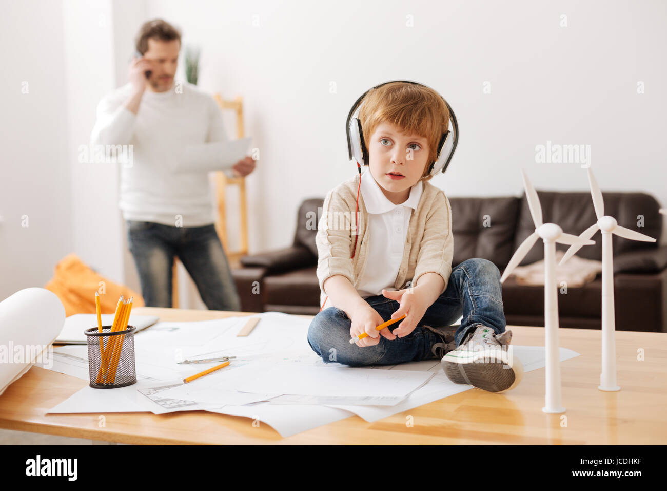 Frustrated boy sitting on the table Stock Photo - Alamy