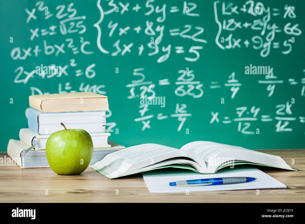 School textbooks on a desk in front of blackboard Stock Photo - Alamy