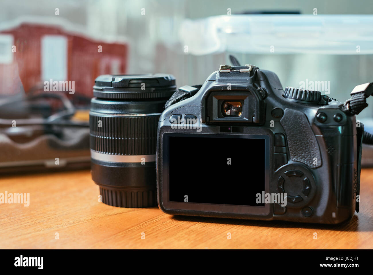 DSLR camera with lens on the wood table Stock Photo - Alamy