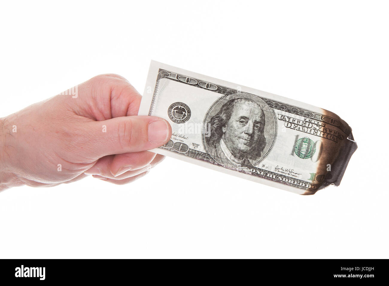 Close-up Of Man's Hand Holding Burnt Currency Note On White Background ...