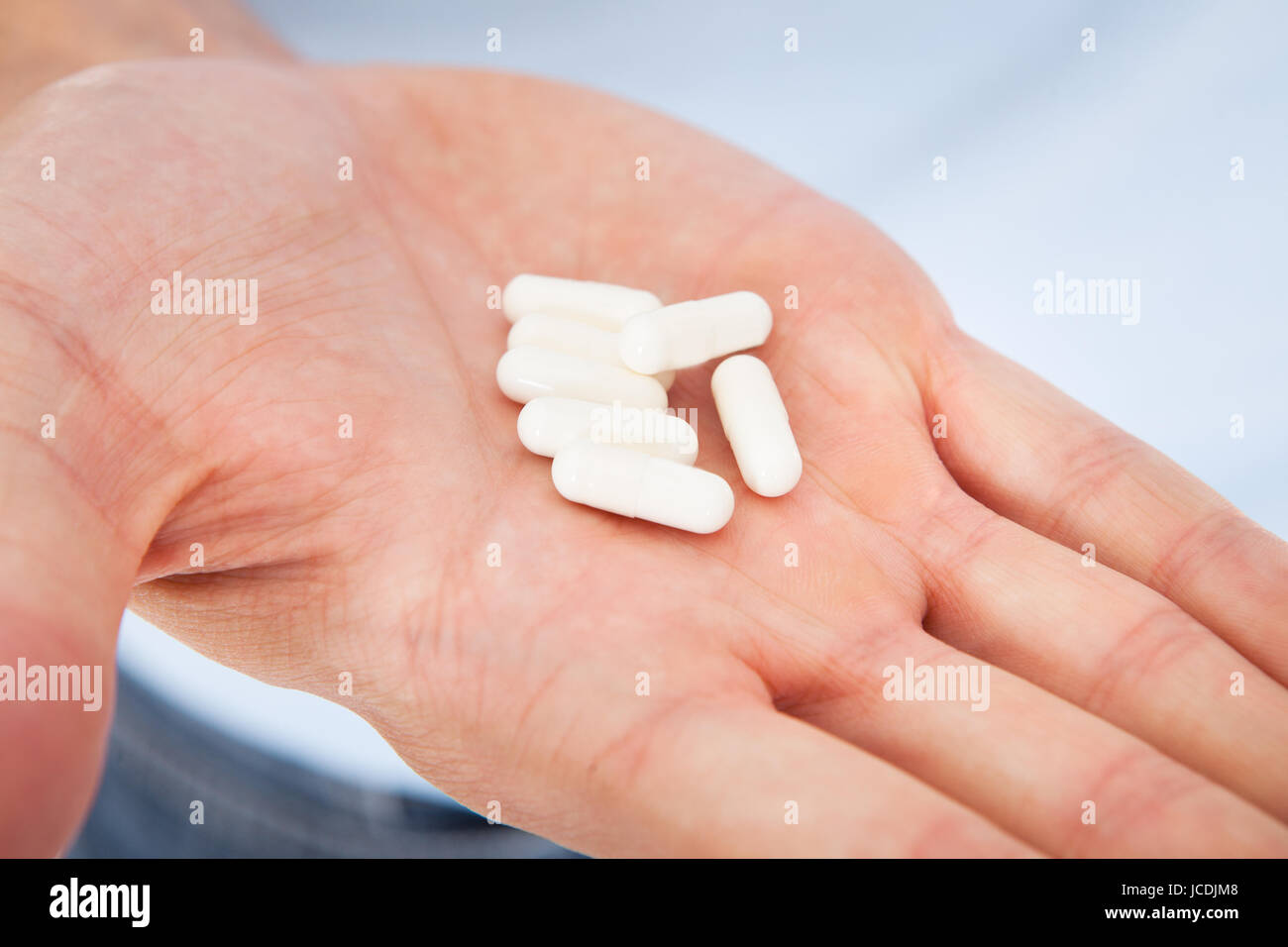 Capsule Held On Palm Of A Person Stock Photo - Alamy