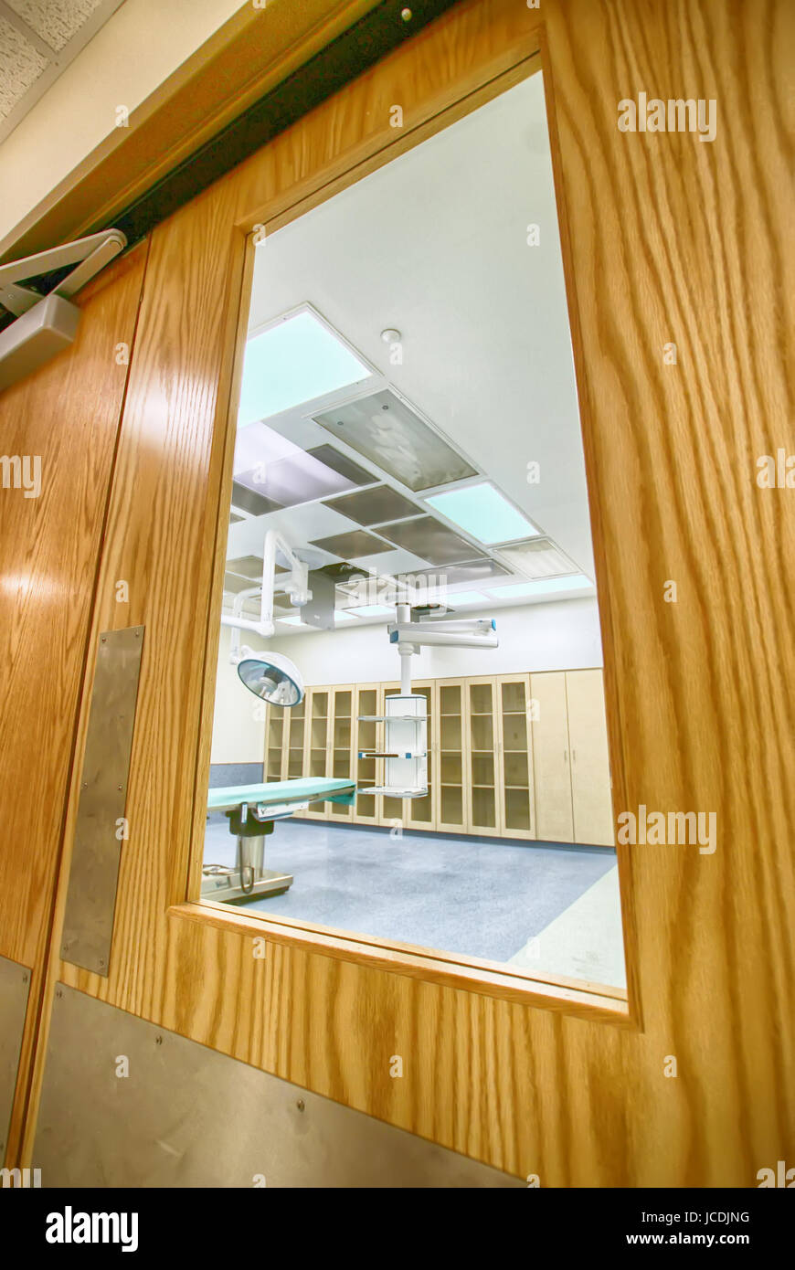 looking through a door glass window into a surgery room Stock Photo - Alamy