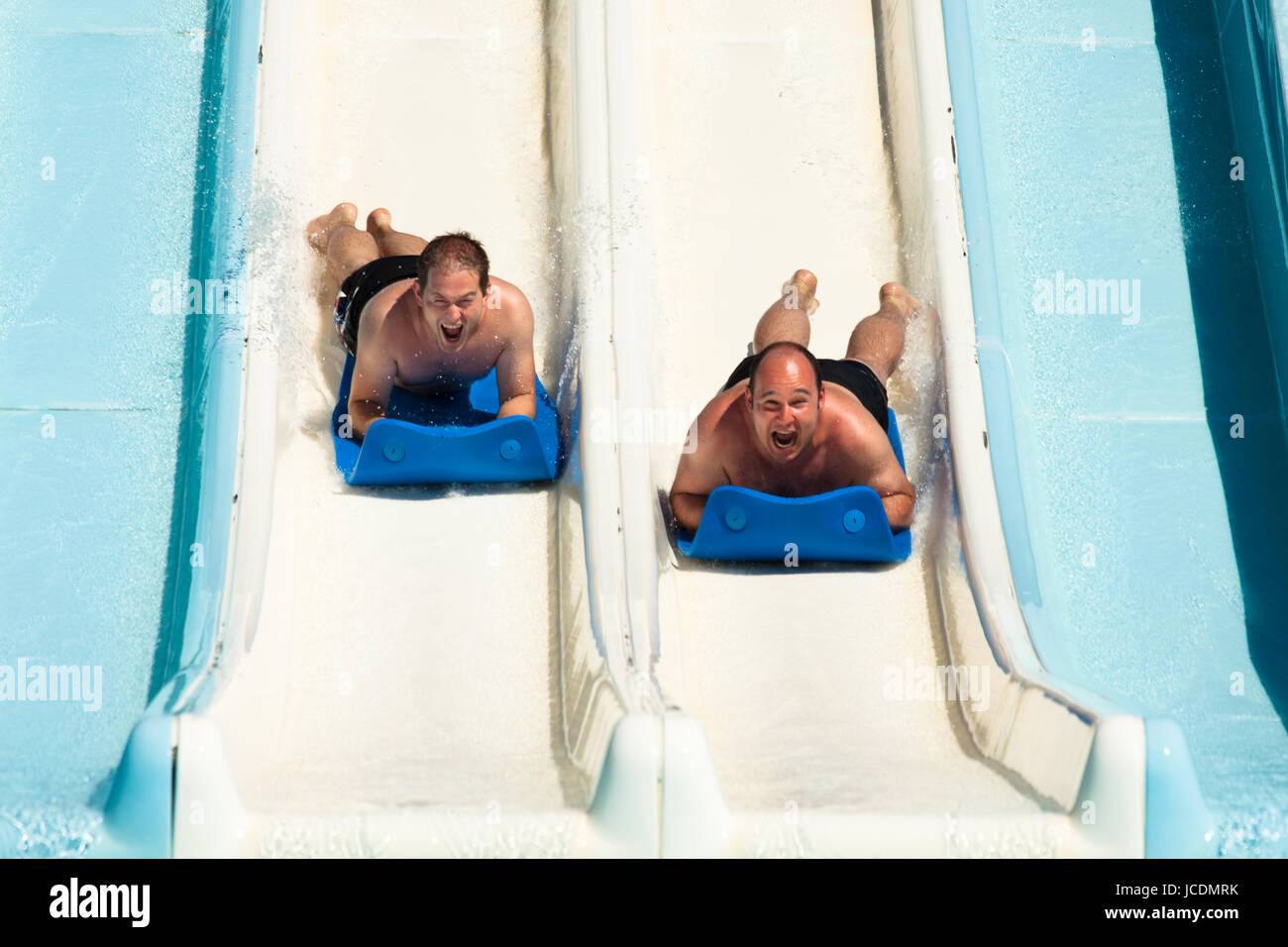 People having fun, sliding at water park Stock Photo - Alamy