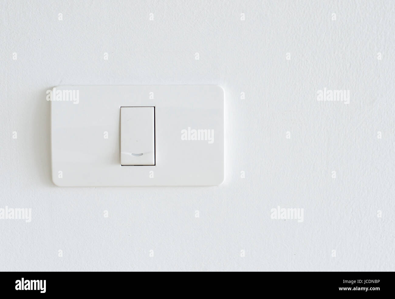 Lighting switch on white wall,modern light switch Stock Photo - Alamy