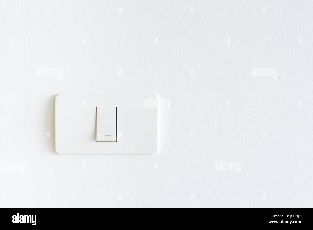 Lighting switch on white wall,modern light switch Stock Photo - Alamy