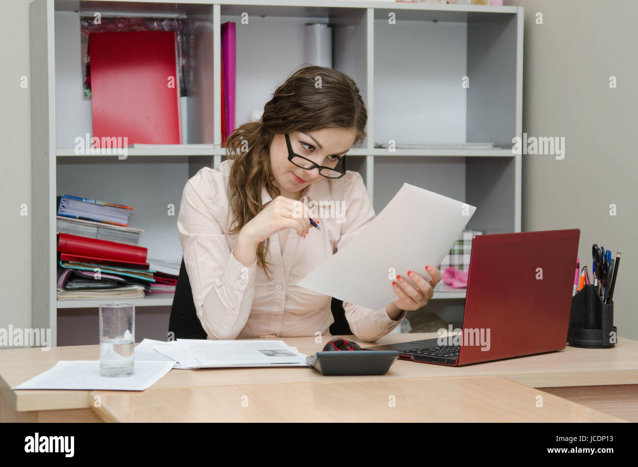 Young girl working at the desk in the office Stock Photo - Alamy