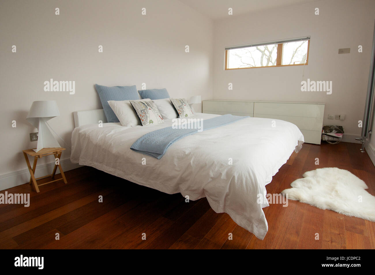 Interior of a modern house - bedroom with bed Stock Photo - Alamy