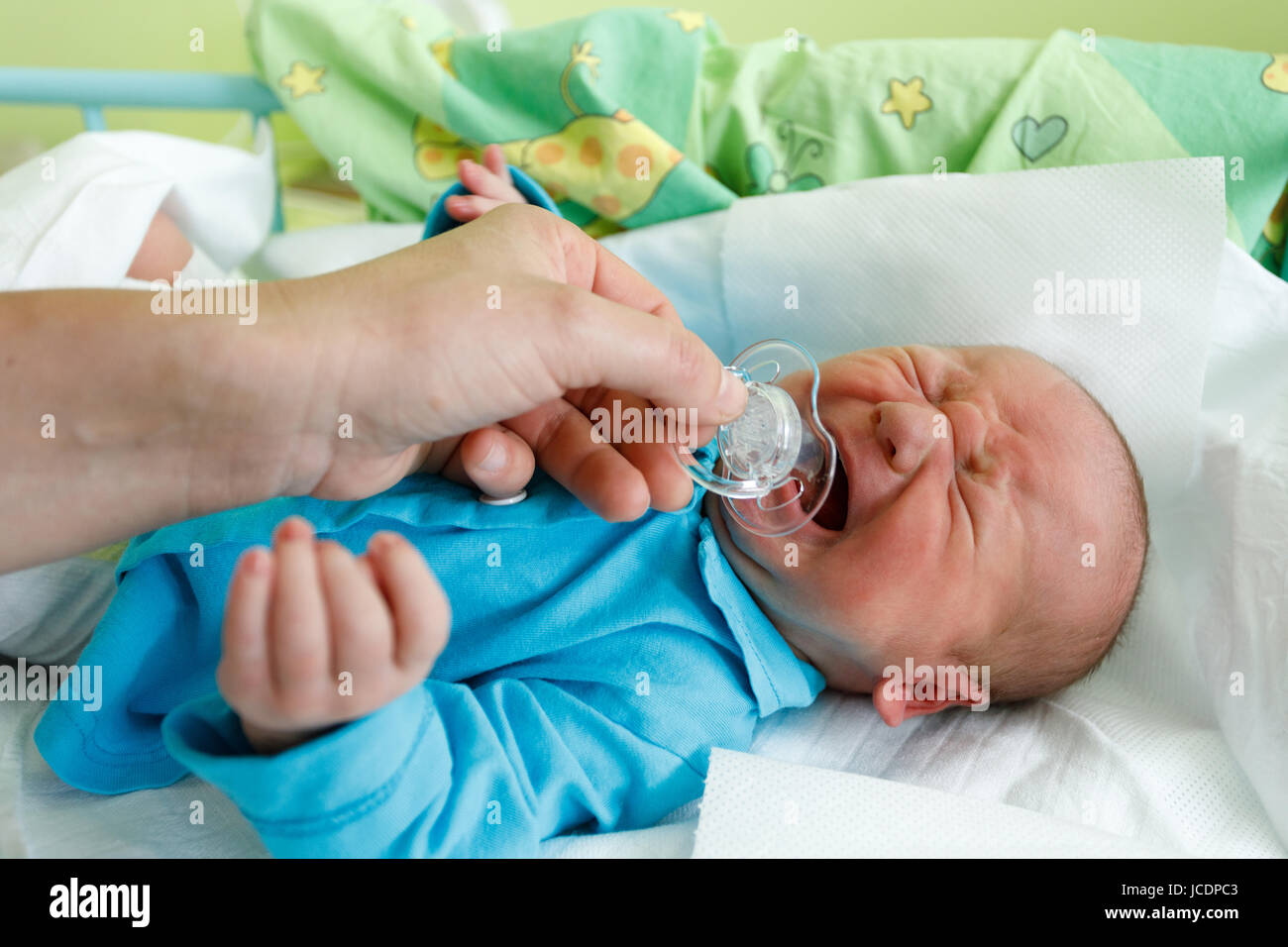 crying newborn baby infant in the hospital, the first hours of the new ...