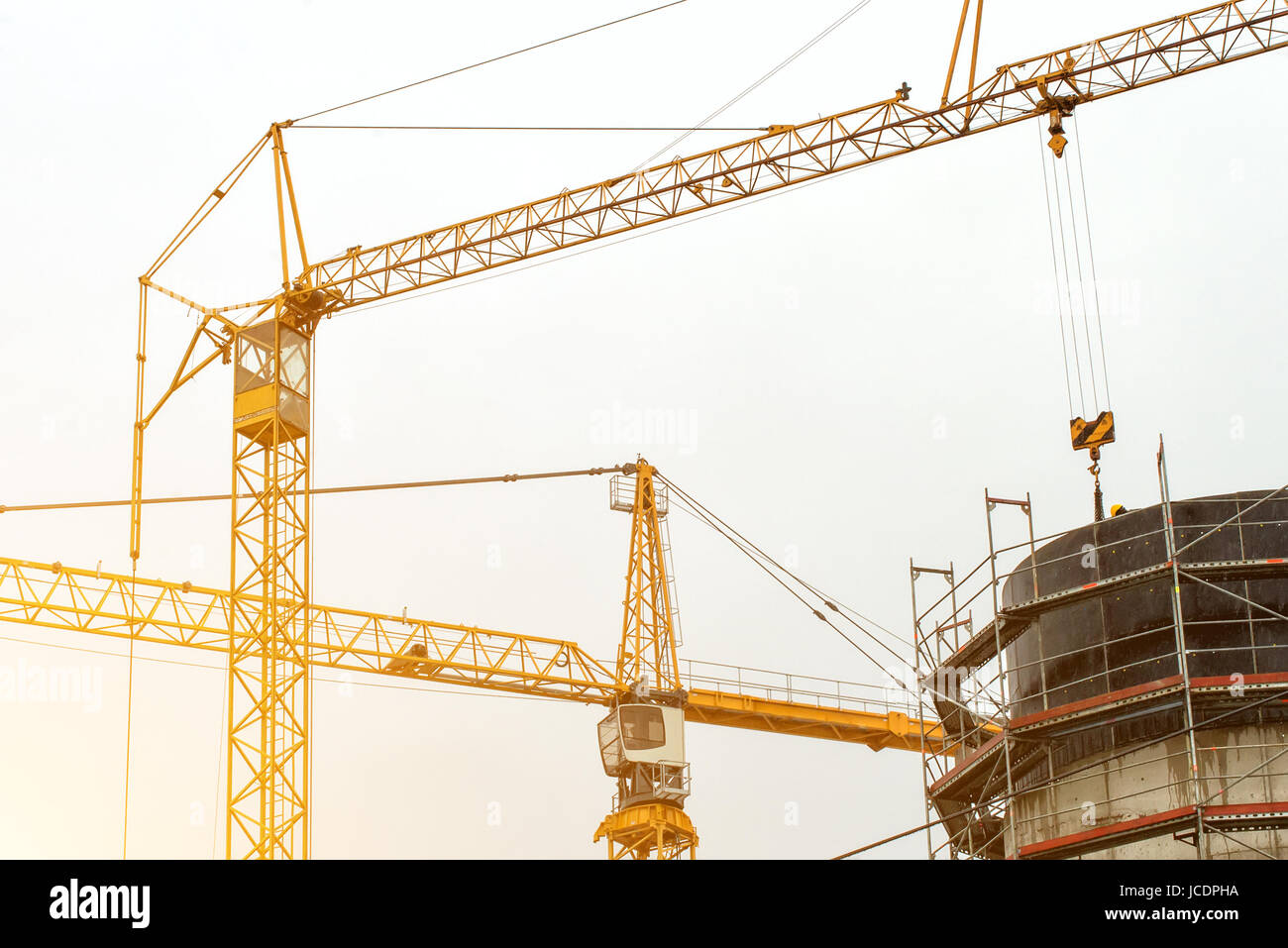Industrial construction cranes in the city Stock Photo - Alamy