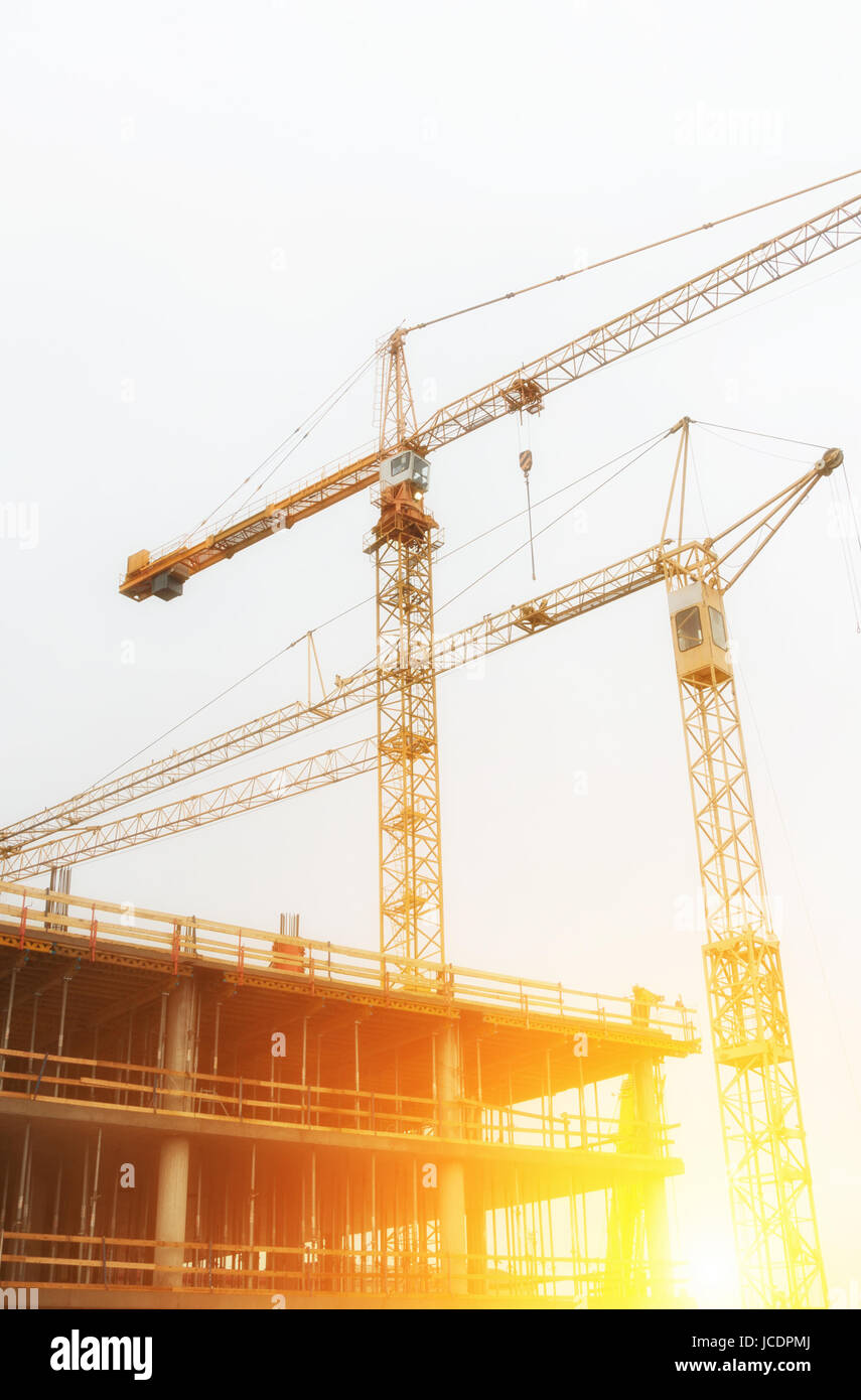 Industrial construction cranes in the city Stock Photo - Alamy