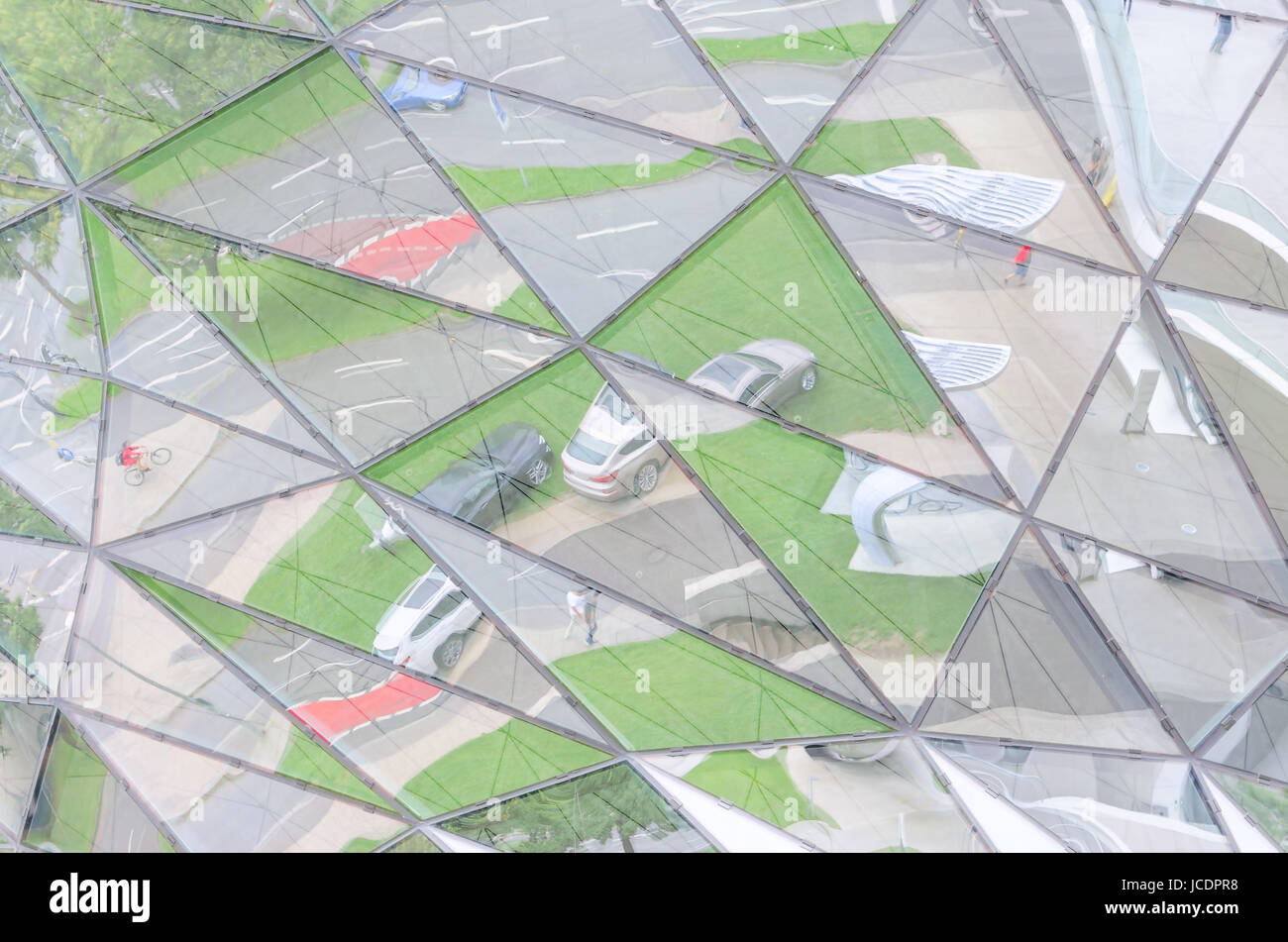 Urban lifestyle reflected in mirrored glass wall and divided into ...