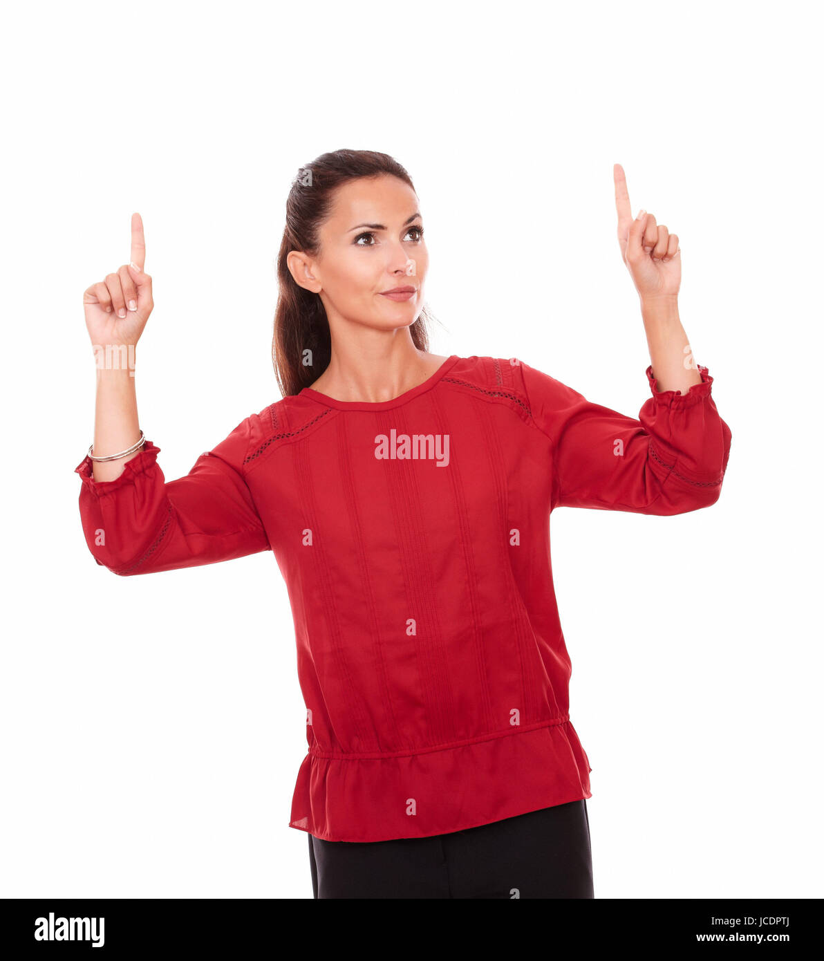 Portrait of charming latin female pointing up her fingers while looking ...