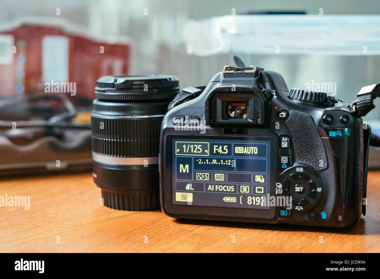 DSLR camera with lens on the wood table Stock Photo - Alamy
