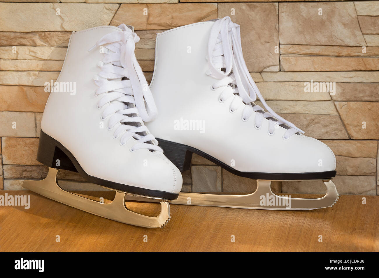 The skates and graceful boots of white color for figure skating on ice ...