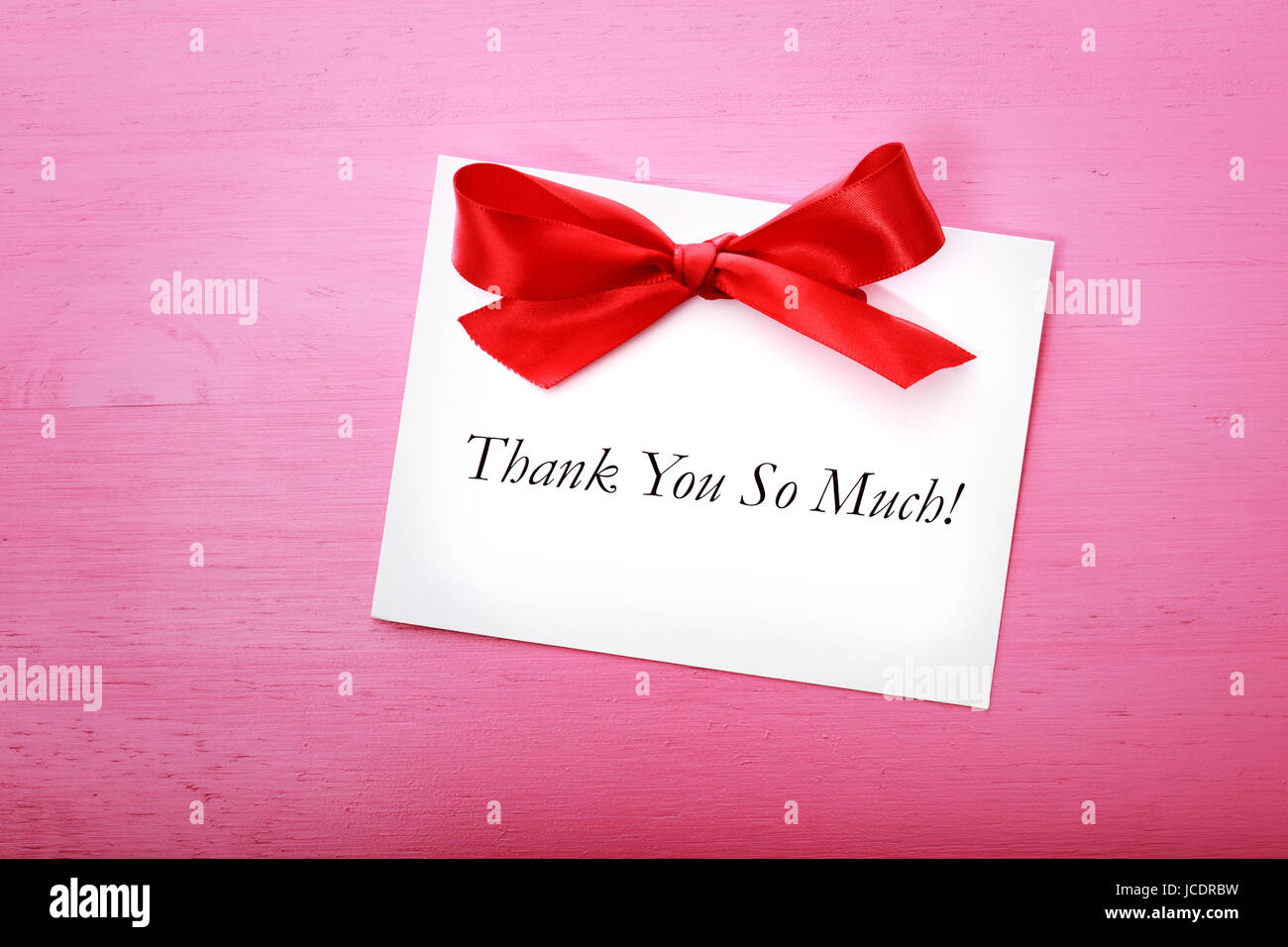 Thank you card with red ribbon on pink wooden board Stock Photo - Alamy