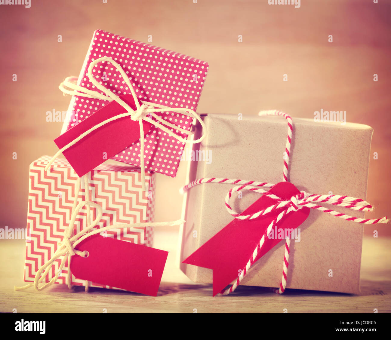 Red and white present boxes with labels and string ribbons Stock Photo ...
